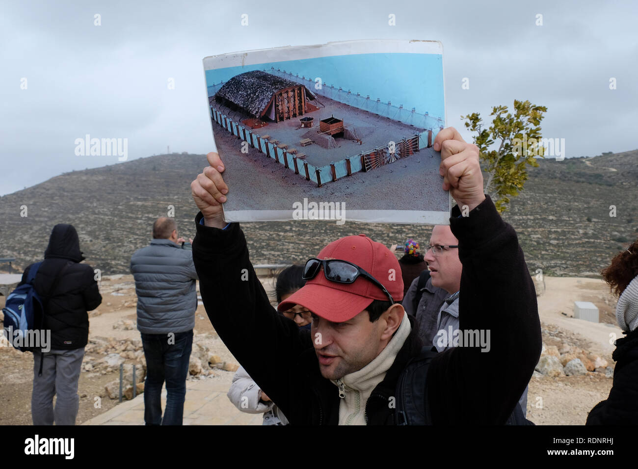 An Israeli archeologist holds an illustration depicting the Mishkan ...