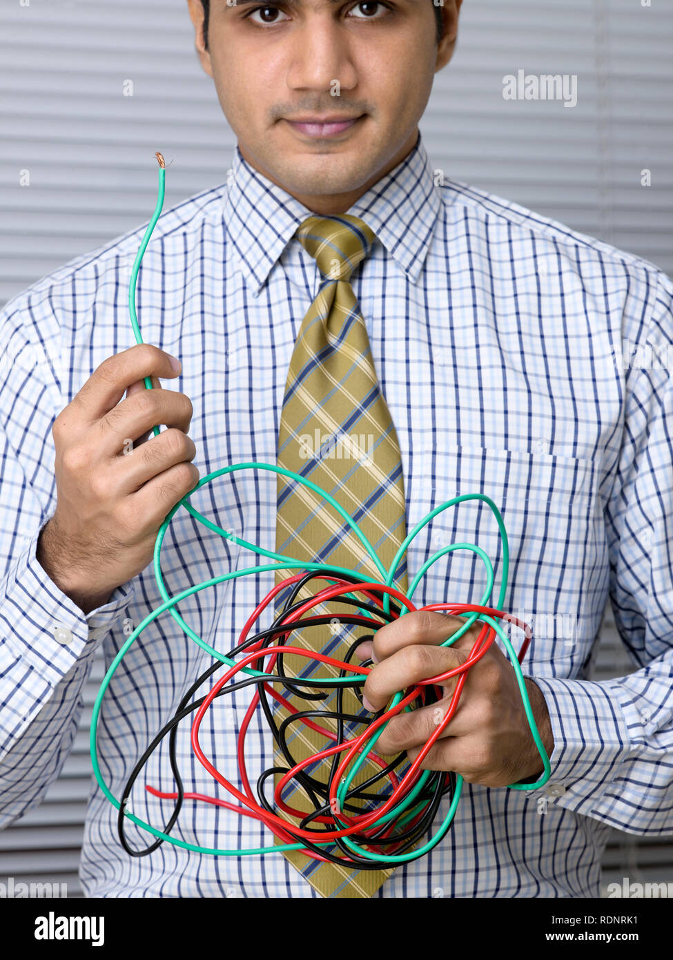 CORPORATE EXECUTIVE HOLDING A BUNDLE OF WIRES Stock Photo - Alamy