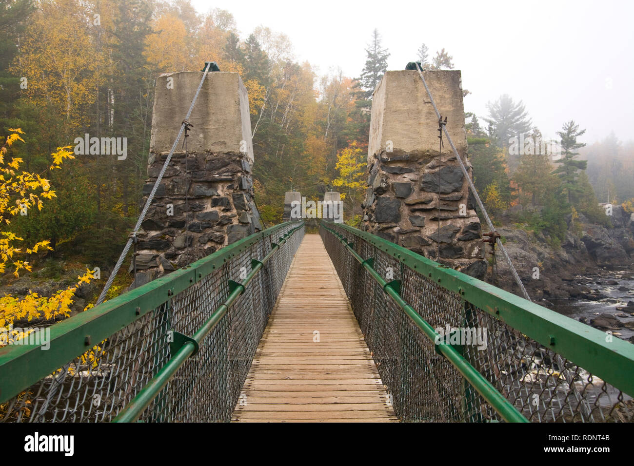 Swinging Bridge and fall color Stock Photo - Alamy