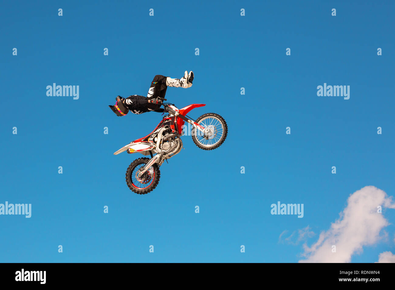 Racer on motorcycle participates in motocross cross-country in flight ...