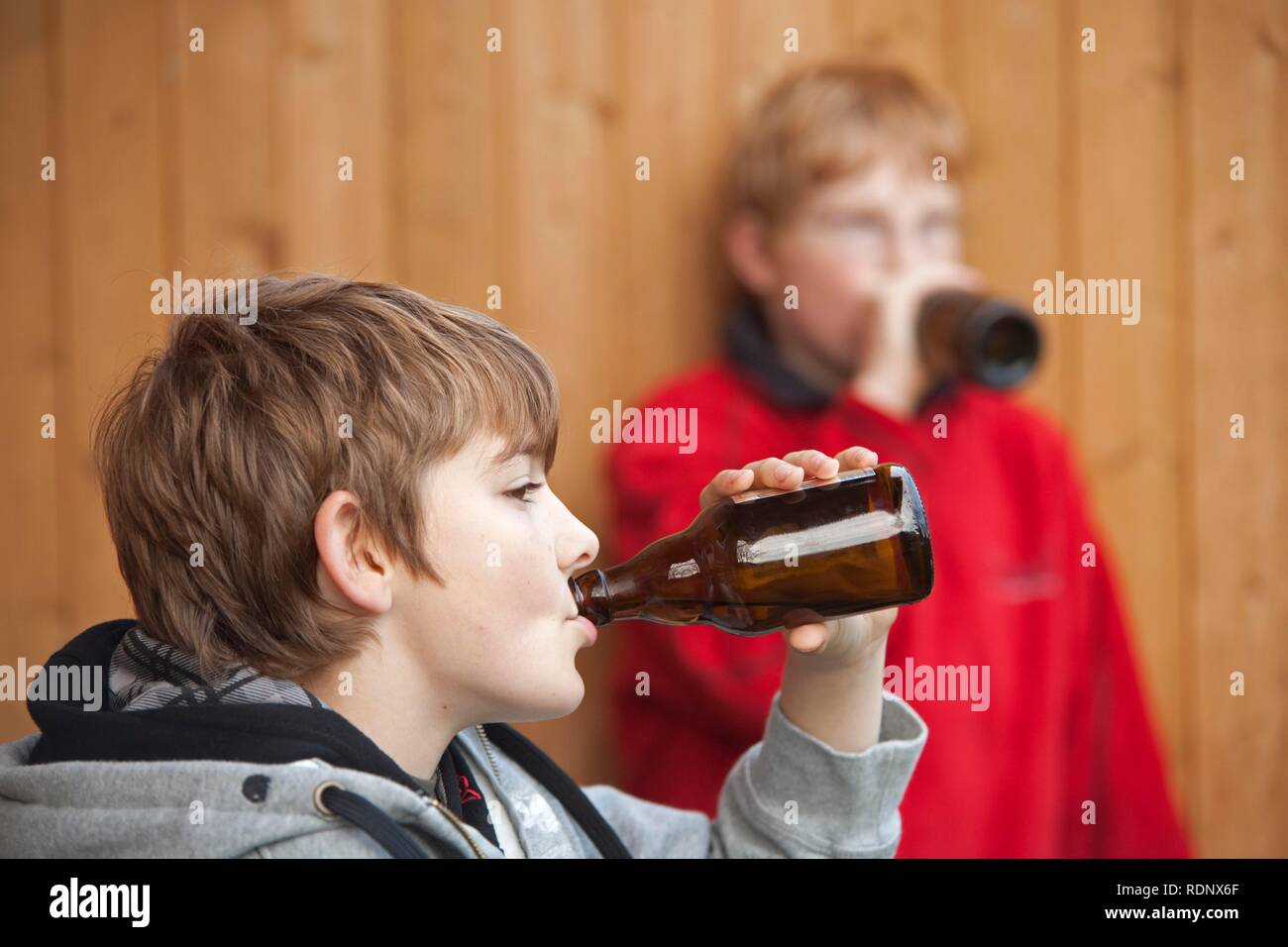 Under-age boys drinking beer, posed scene Stock Photo - Alamy