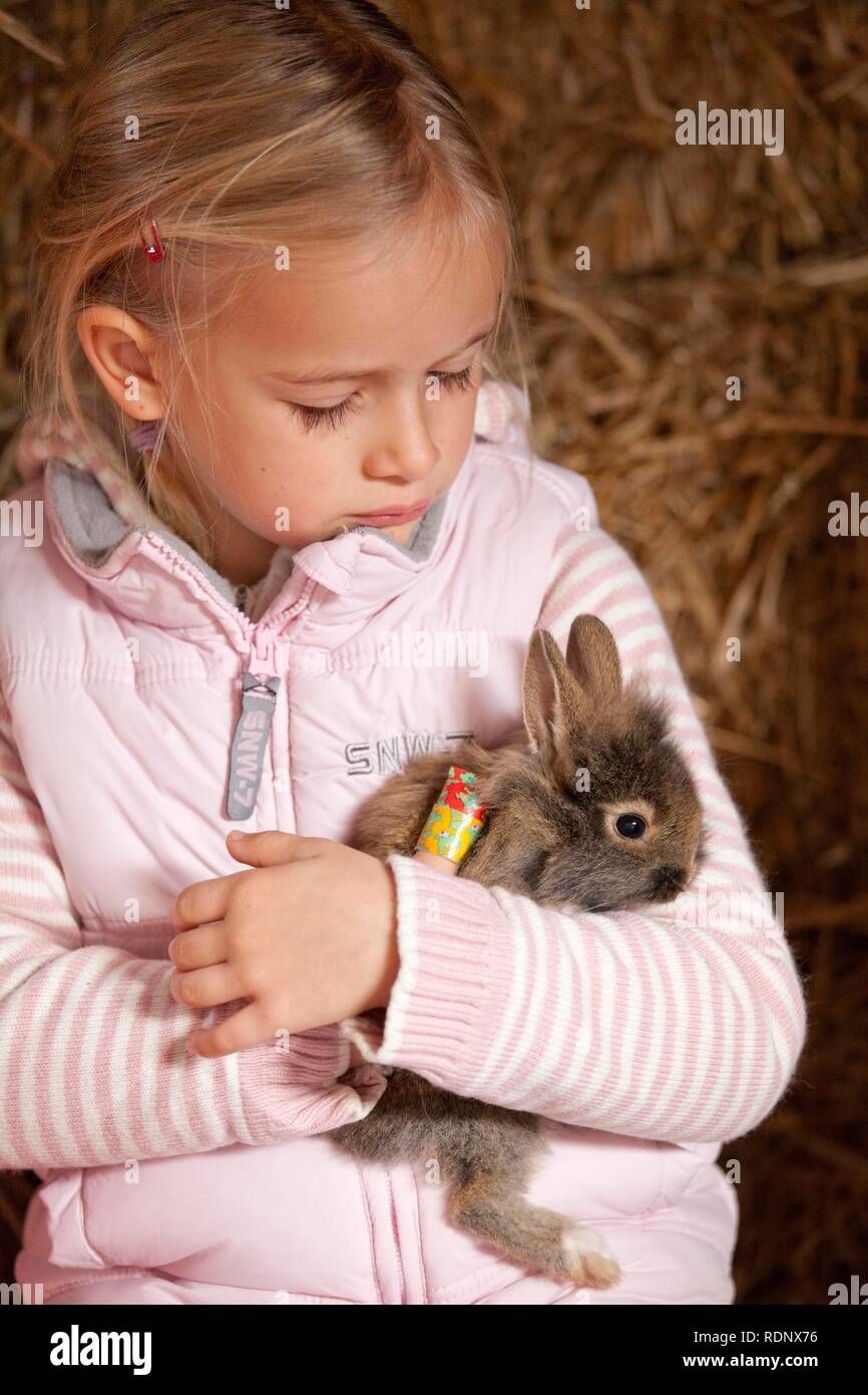 Young girl cuddling with a rabbit Stock Photo - Alamy