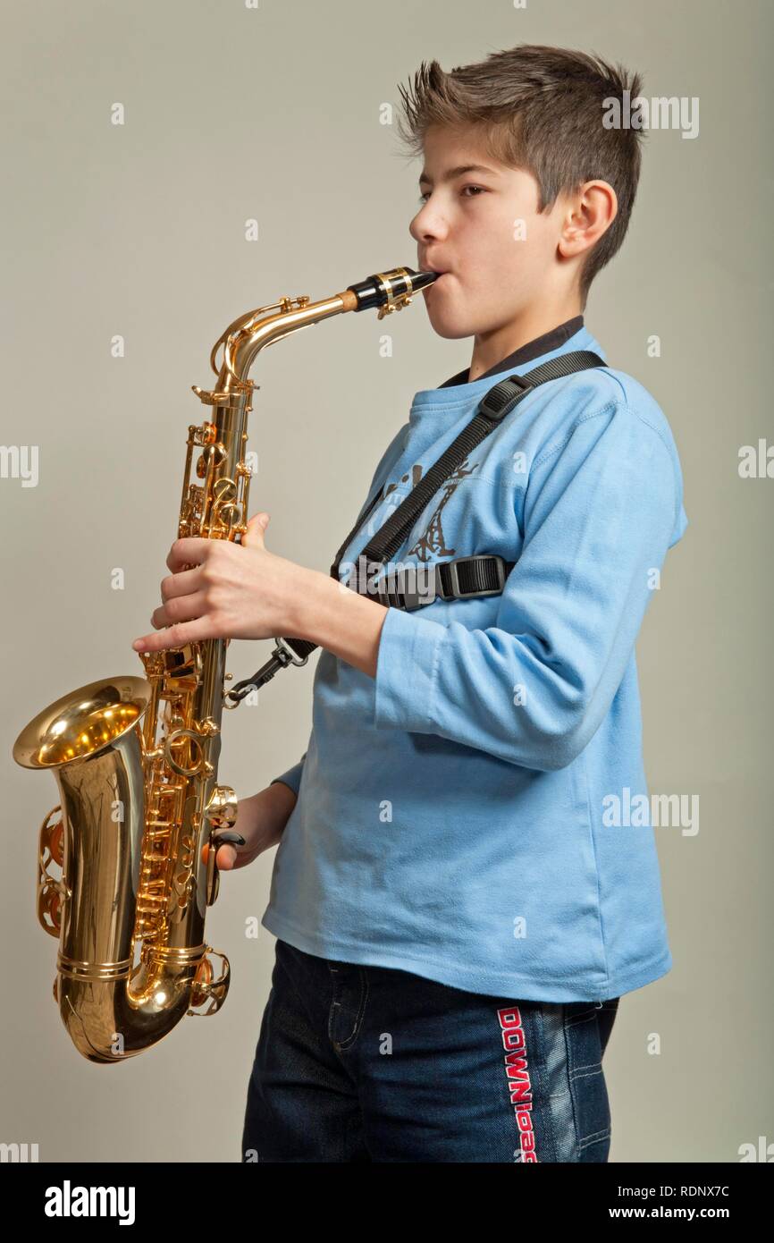 Boy playing the saxophone Stock Photo - Alamy