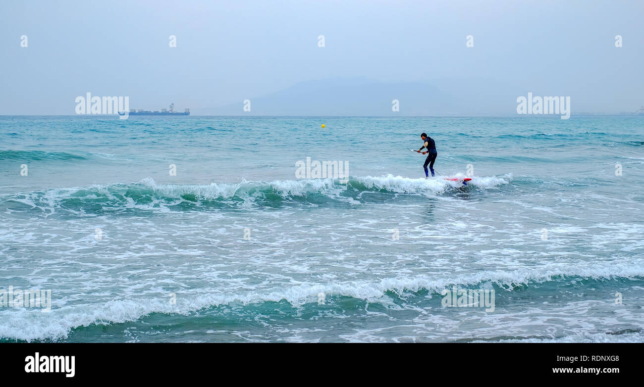 a man paddling on a surfboard in the open sea Stock Photo - Alamy
