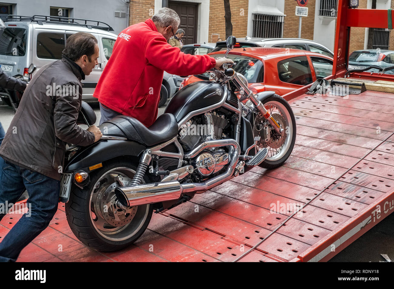 People loading a famous motorcycle on the trailer Stock Photo - Alamy