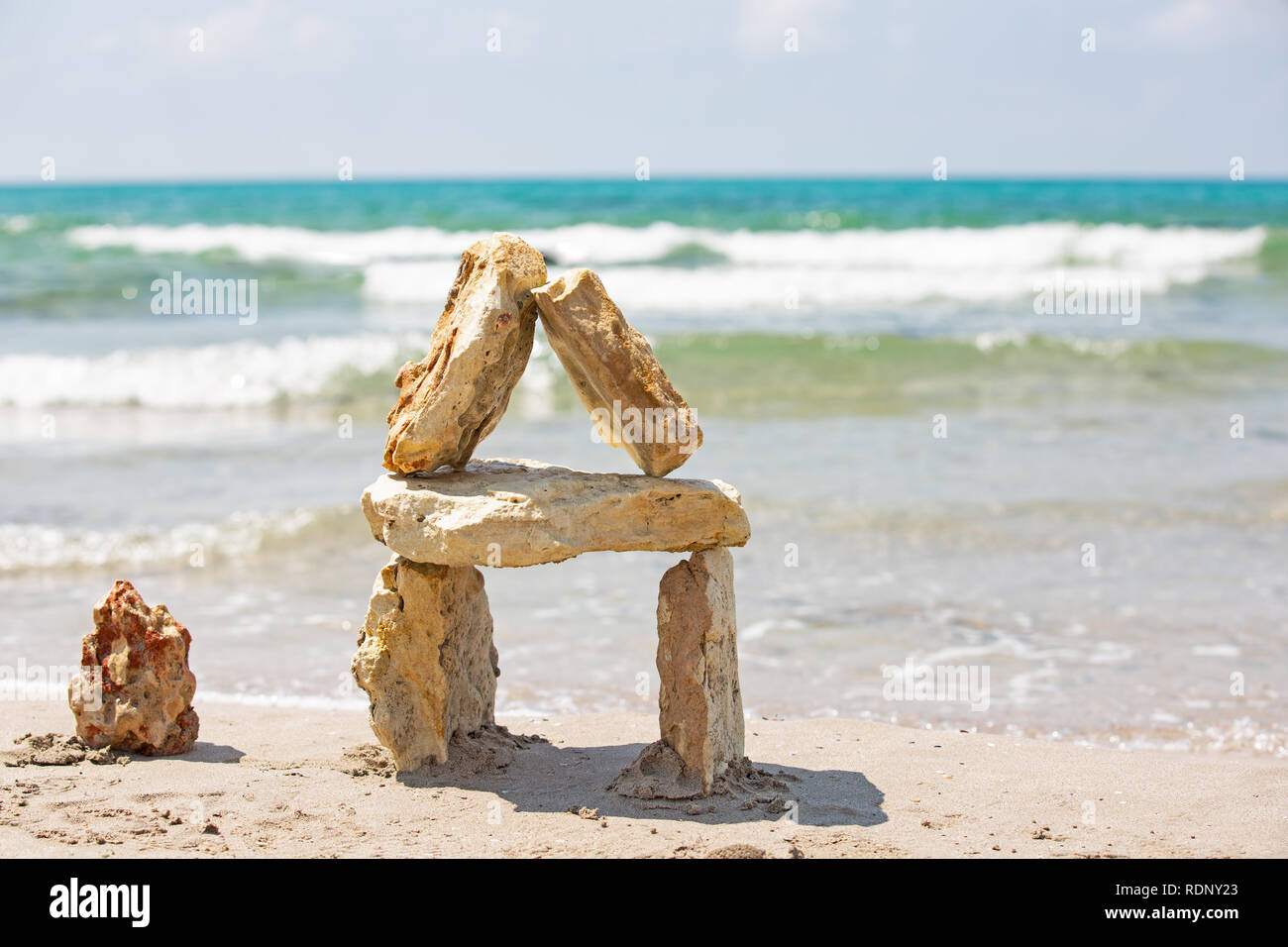 House made of stones against the sea, background sea. Sea stones on the ...