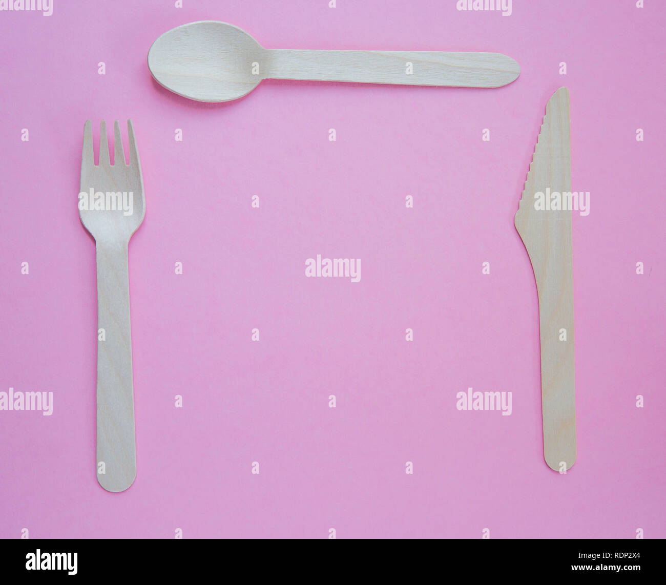 A flat lay of sustainable wooden cutlery including a knife, fork and ...