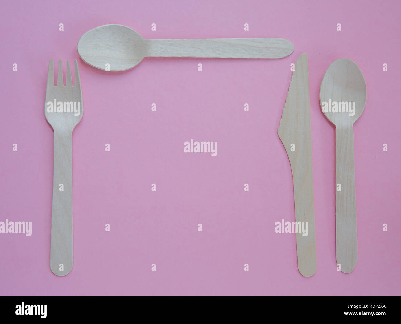 A flat lay of sustainable wooden cutlery including a knife, fork and ...