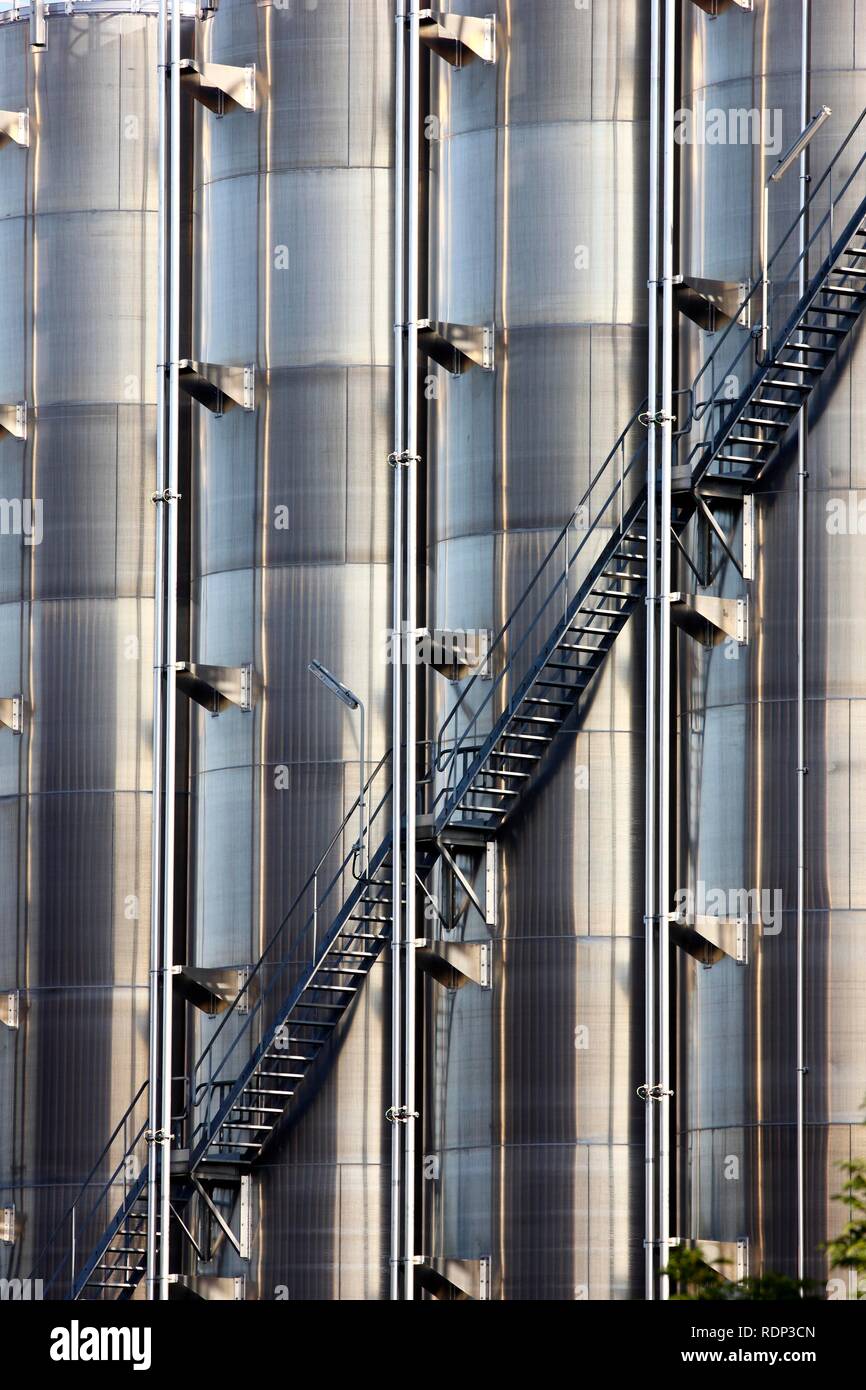 Steep stairs leading up stainless steel tanks, chemical industry ...