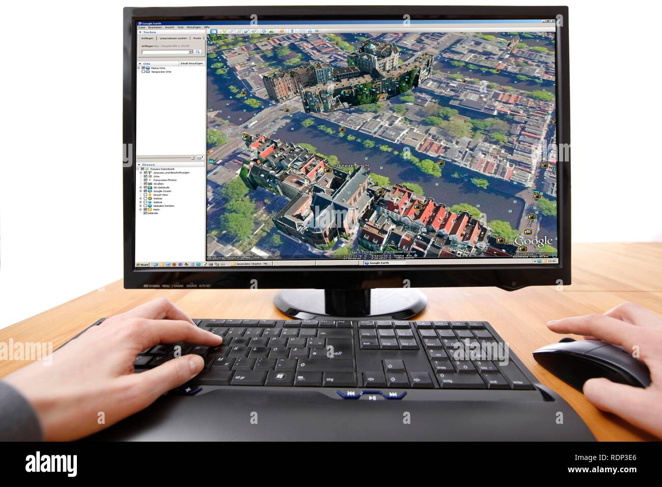 Person sitting at a computer working with Google Street View, screen ...