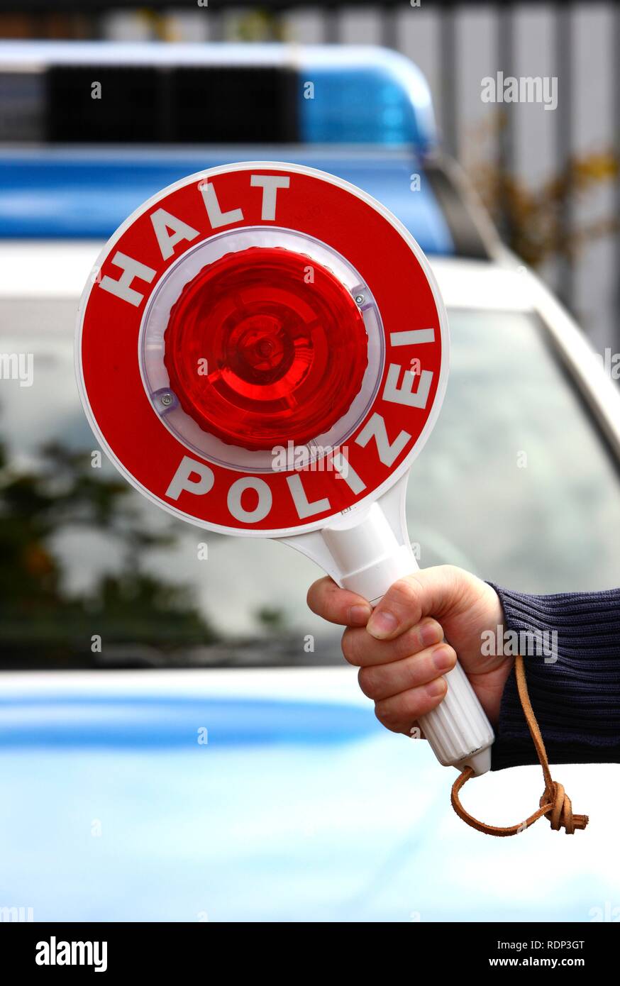 Signalling disc in front of a police car Stock Photo - Alamy