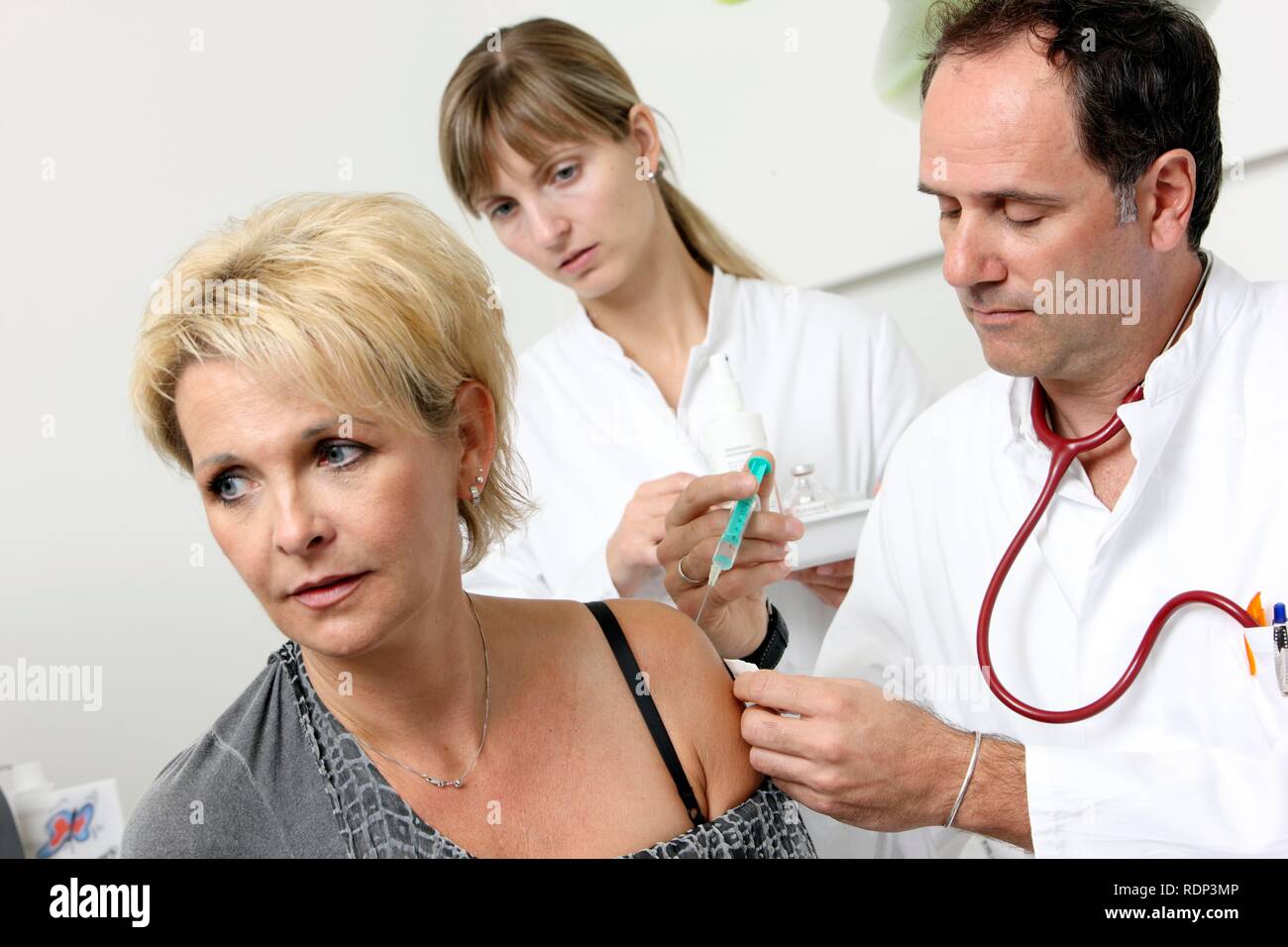 Doctor's surgery, patient having an injection with a disposable syringe ...