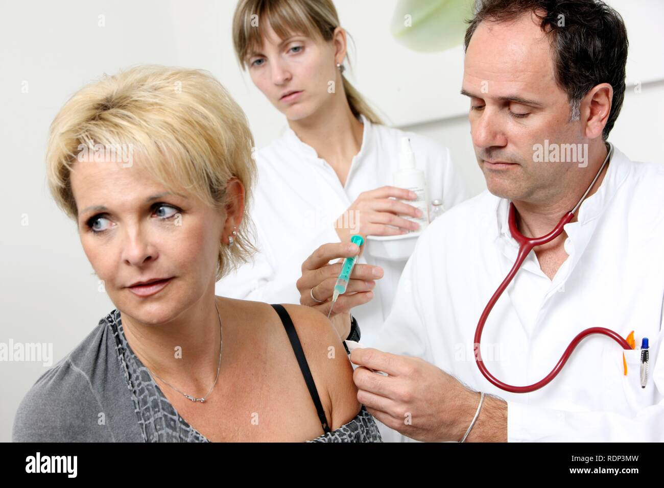 Doctor's surgery, patient having an injection with a disposable syringe ...