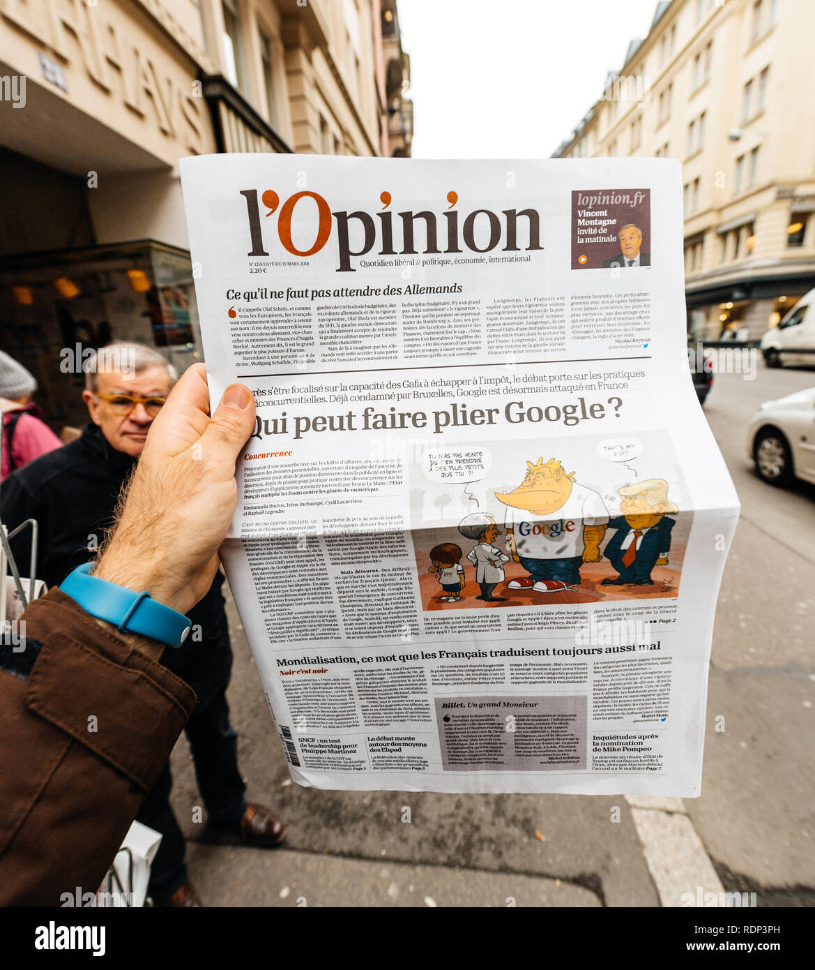 PARIS, FRANCE - MAR 15, 2018: POV man holding Opinion French newspaper ...