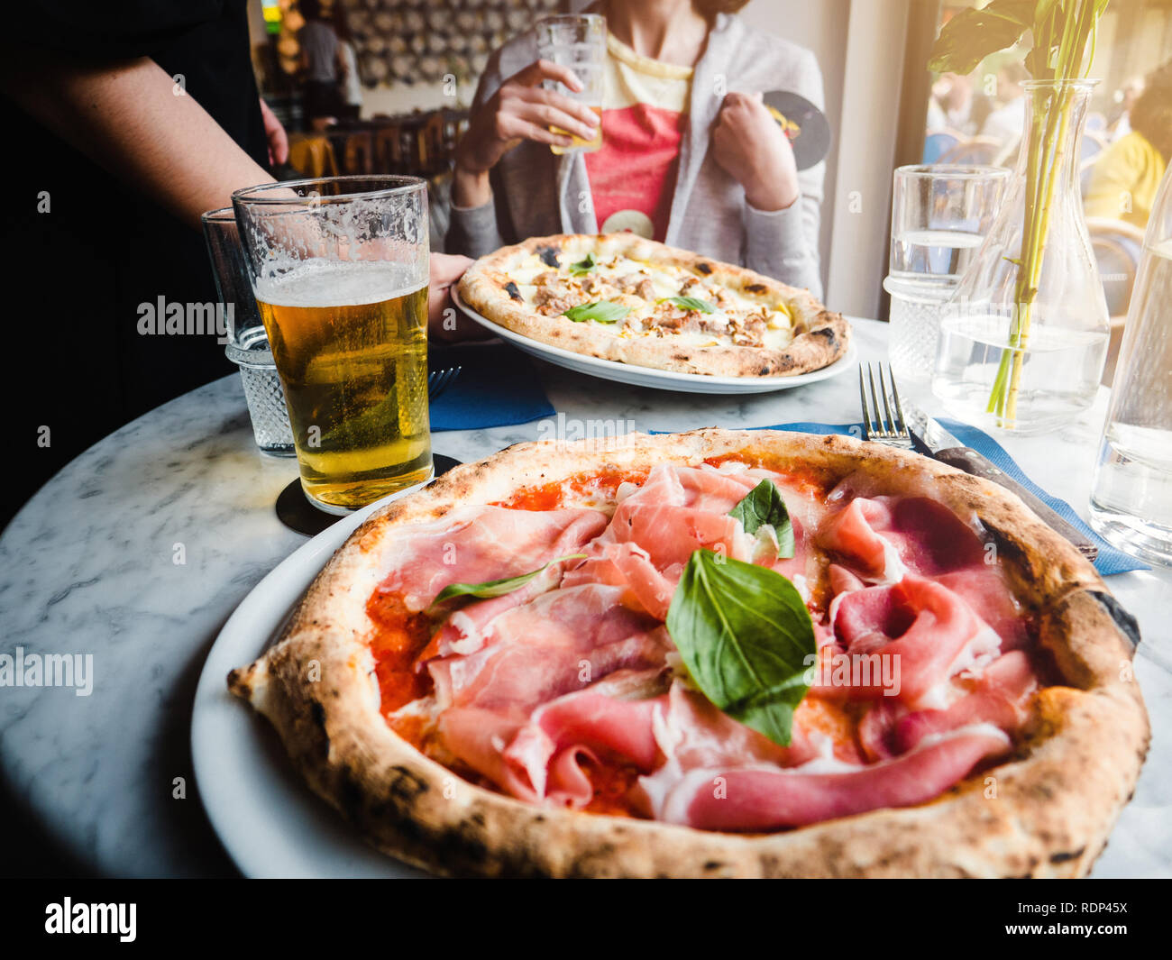 Waiter bring pizza to woman delicious pizza Salsiccia e Carciofi made ...