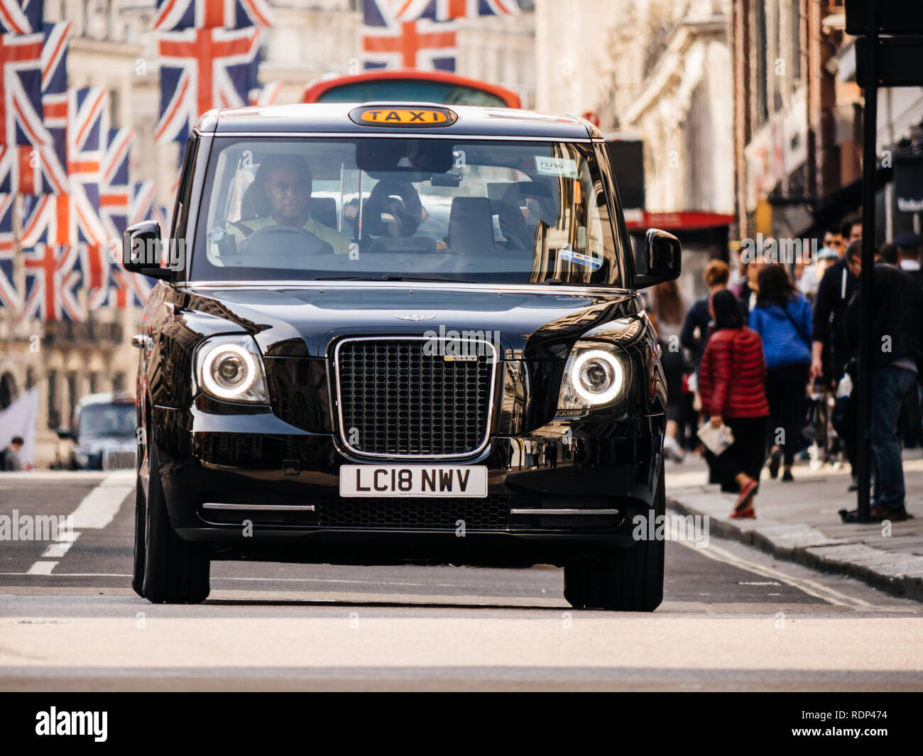 Union jack taxi under a union jack hi-res stock photography and images ...