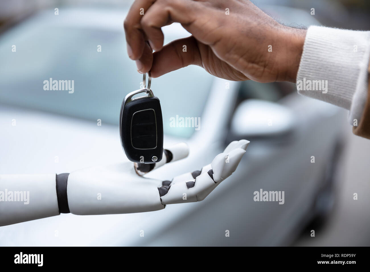 Robot hand giving car key hi-res stock photography and images - Alamy