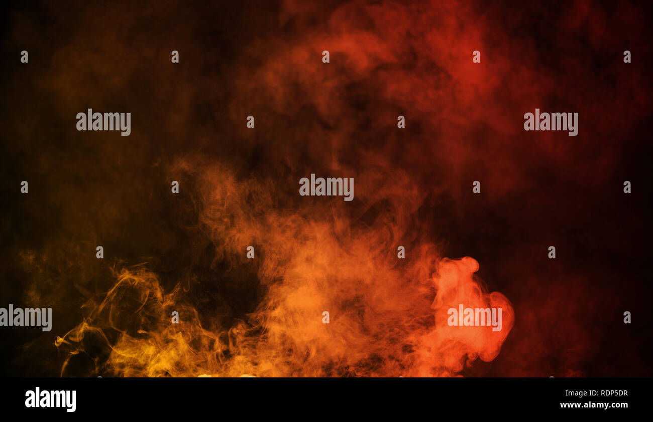 Abstract orange vs red smoke steam moves on a black background . The ...