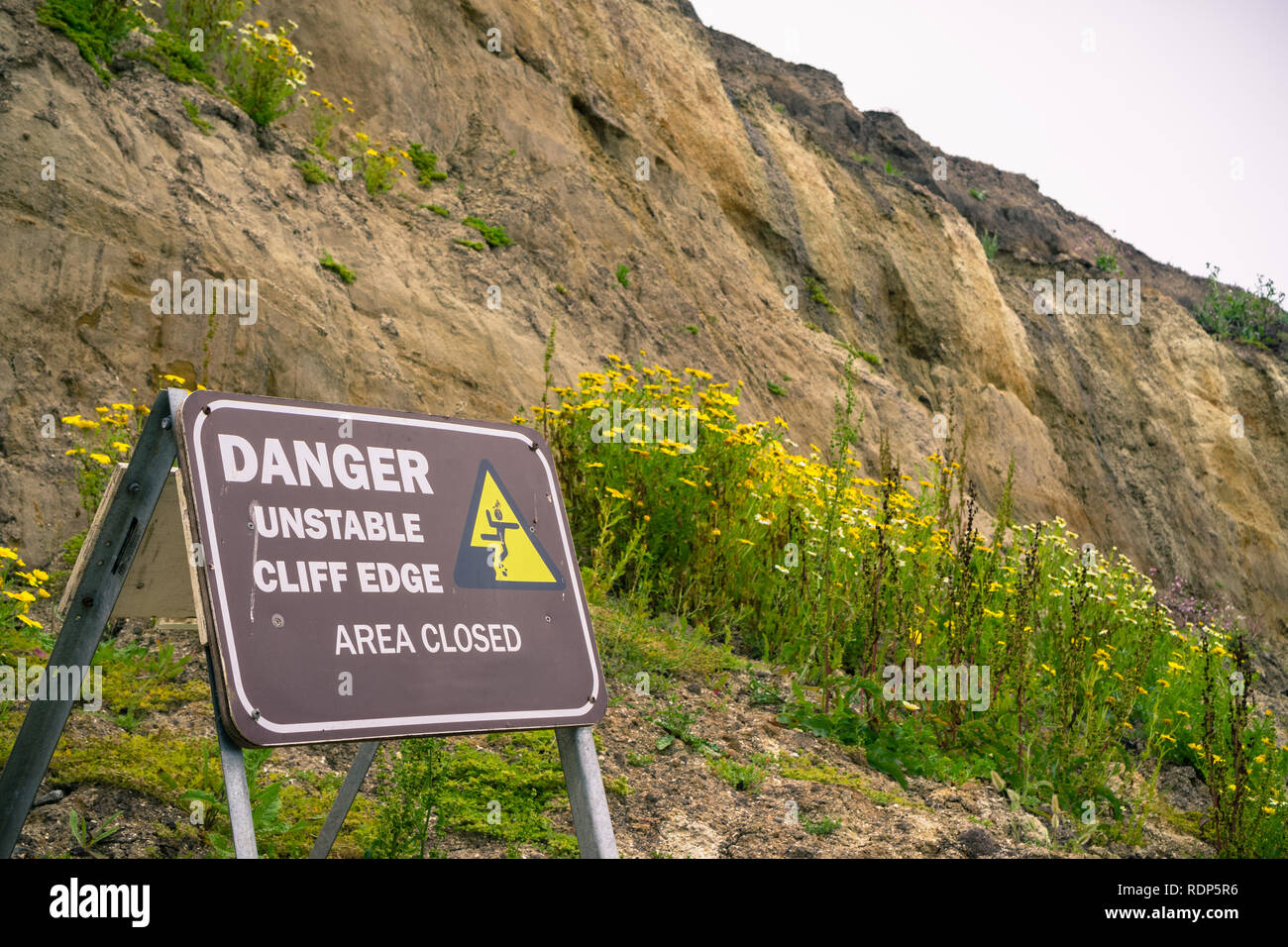 "Danger, unstable cliff edge" sign on the Pacific Ocean coastline ...