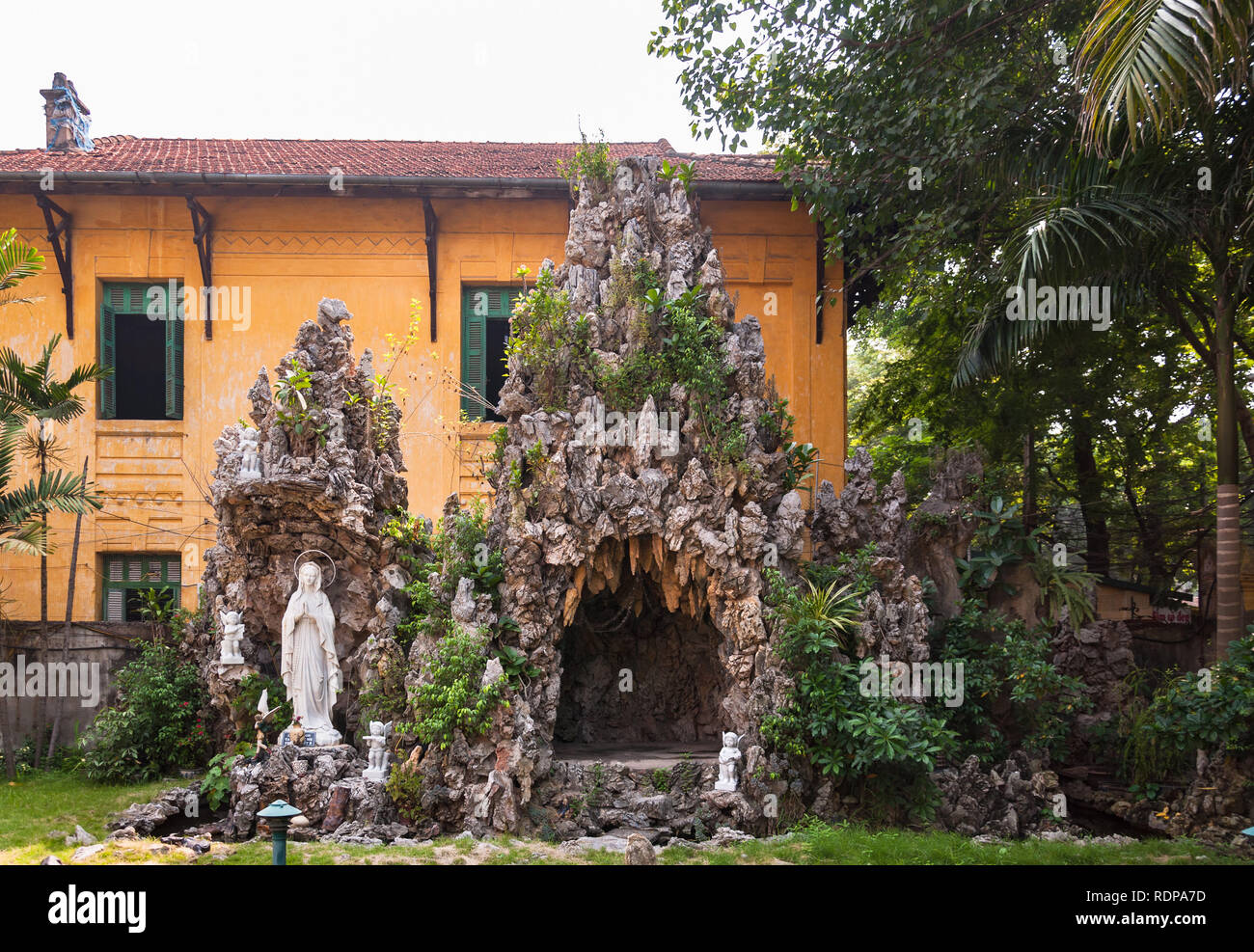 A large shrine made from stone with a statue of the Virgin Mary beside ...