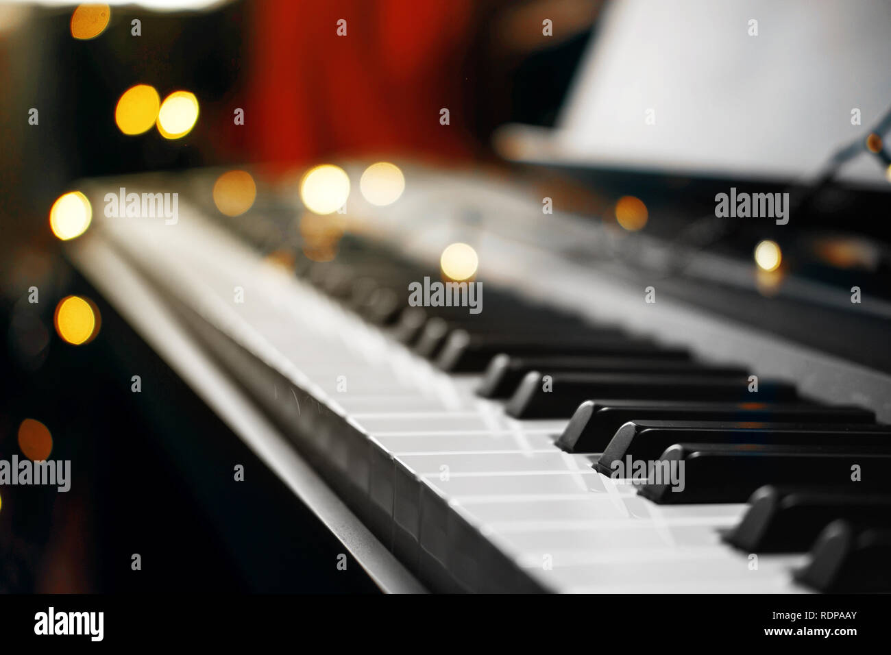 piano keys with beautiful yellow lights bokeh in background, piano keys ...