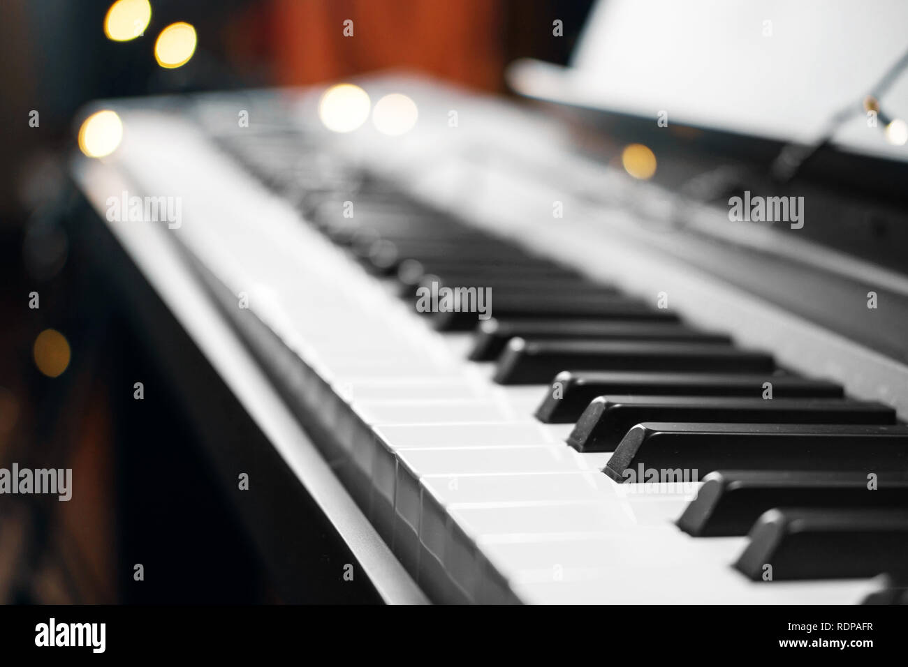 piano keys with beautiful yellow lights bokeh in background, piano keys ...