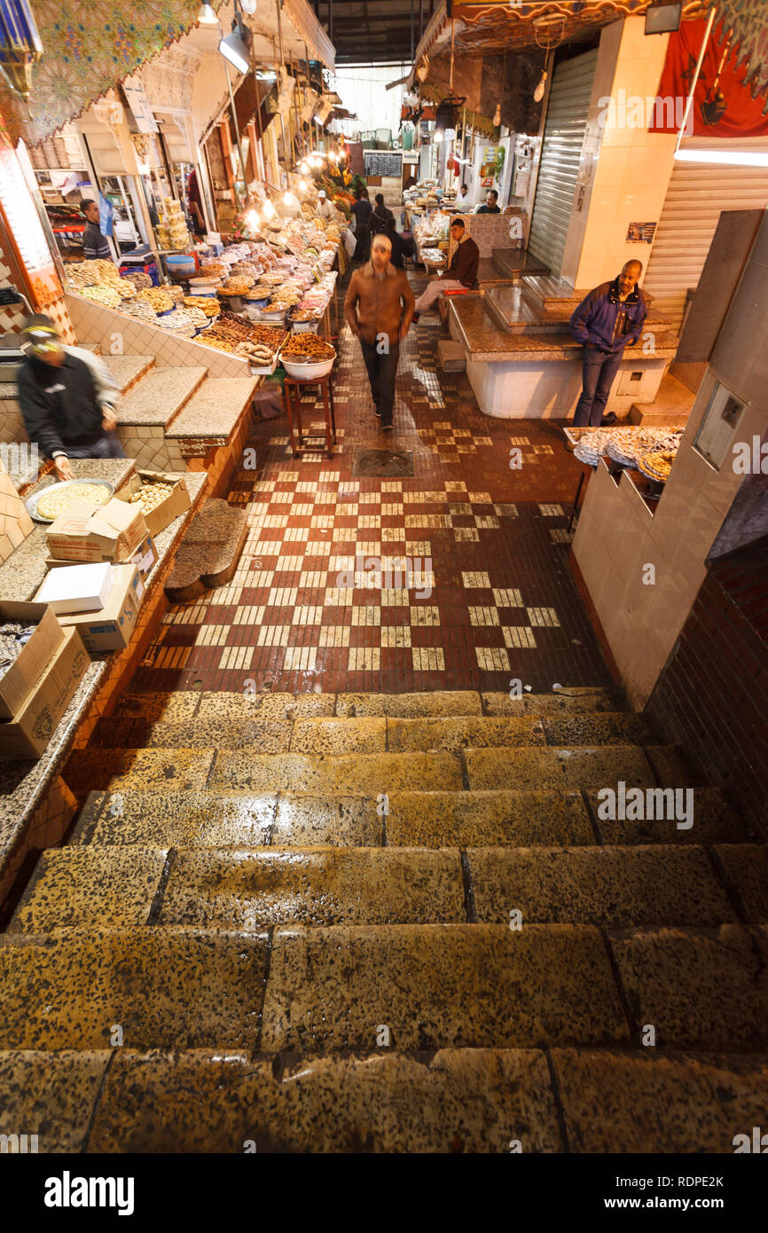 Row of traditional food market stalls displaying wares and vendors in ...