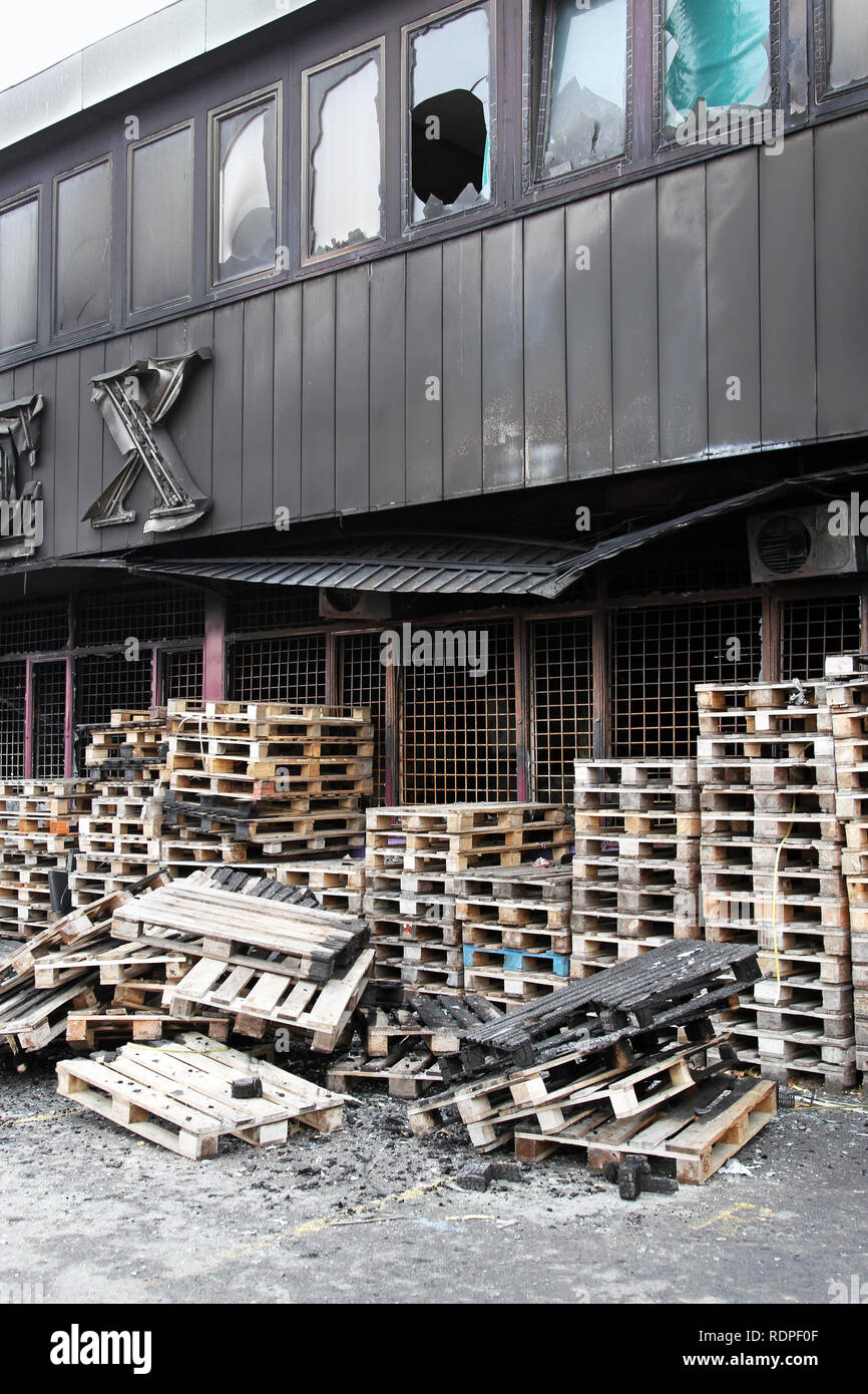 Damaged factory and industrial pallets after fire inferno Stock Photo ...