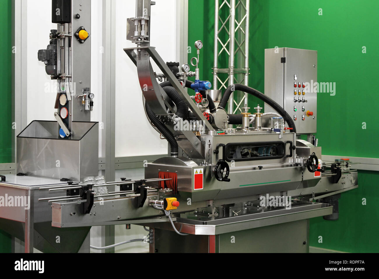 Packaging machine for glass jars with lids Stock Photo - Alamy