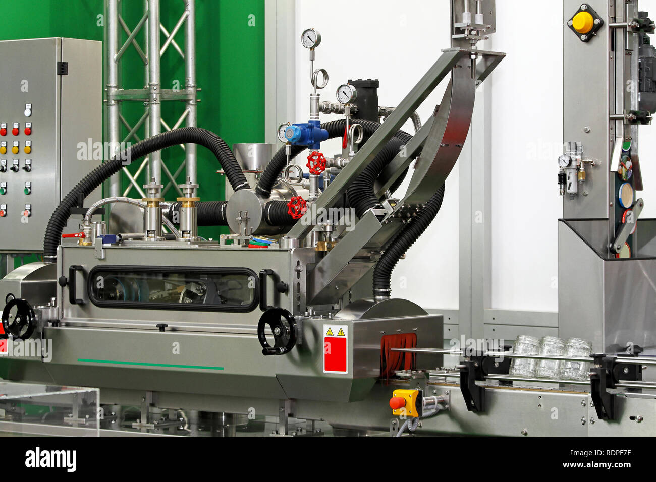 Packaging machine for glass jars with lids Stock Photo - Alamy