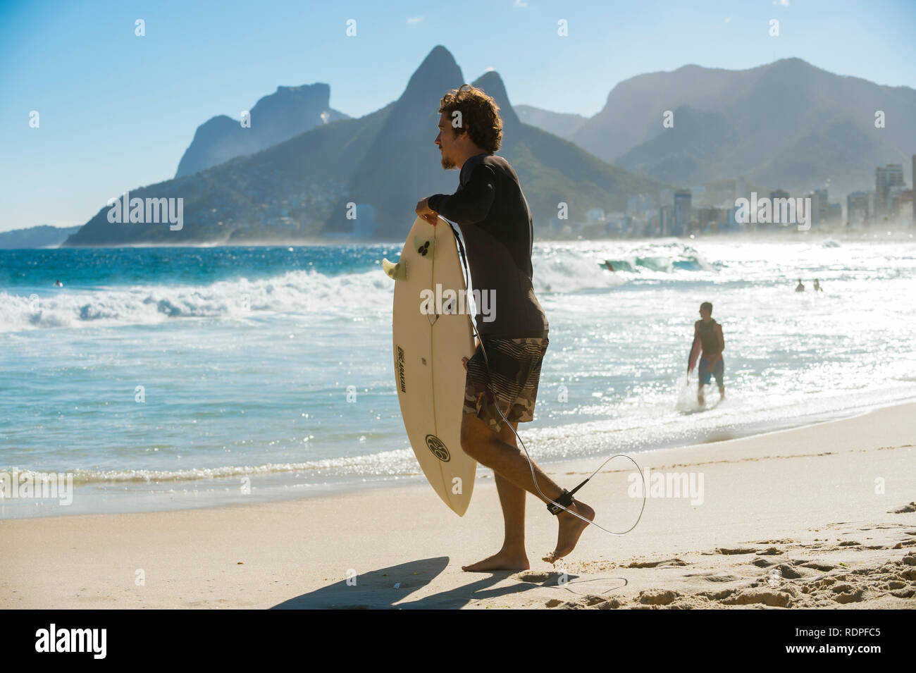 RIO DE JANEIRO - MARCH 20, 2017: Young Brazilian surfers carry their ...