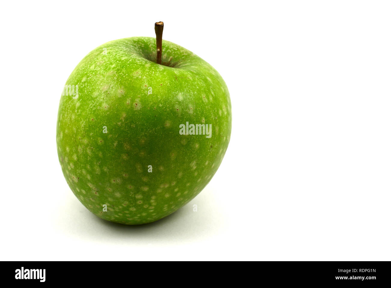 fresh green spotted apple on white background Stock Photo - Alamy