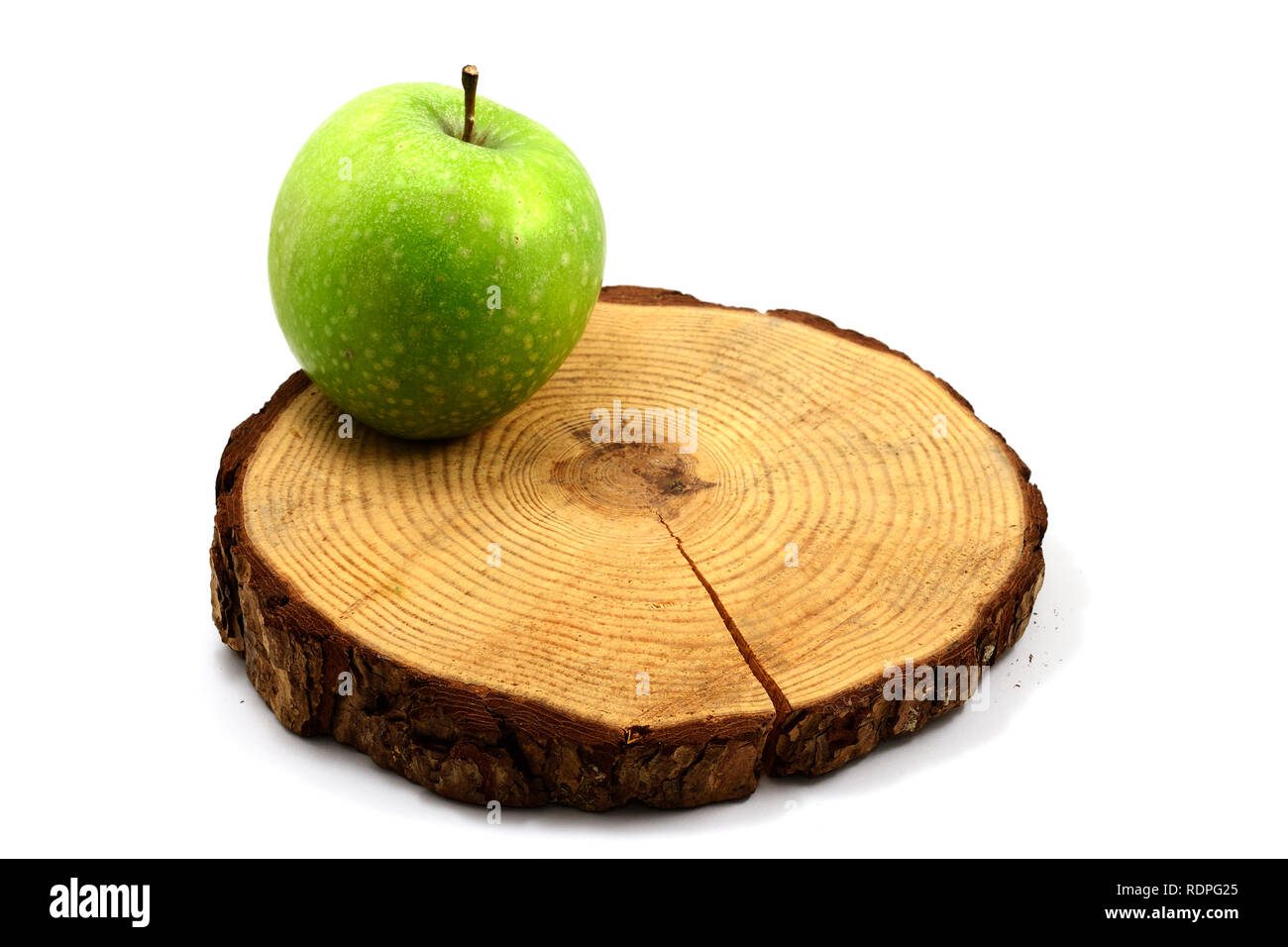 fresh green spotted apple and wooden circle with a split cut Stock ...