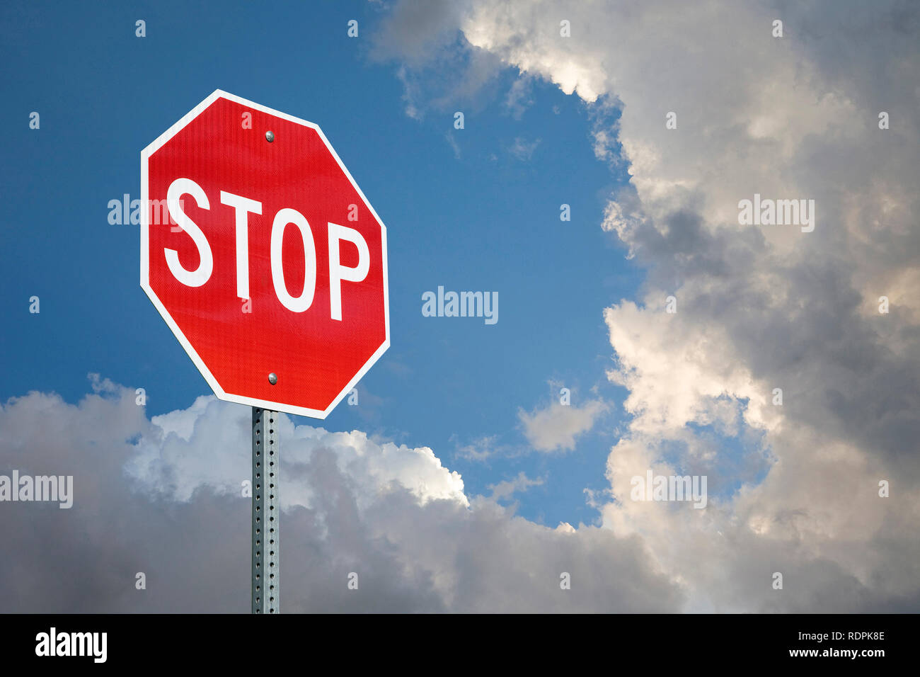 Stop Sign With Blue Sky And Storm Clouds Stock Photo - Alamy