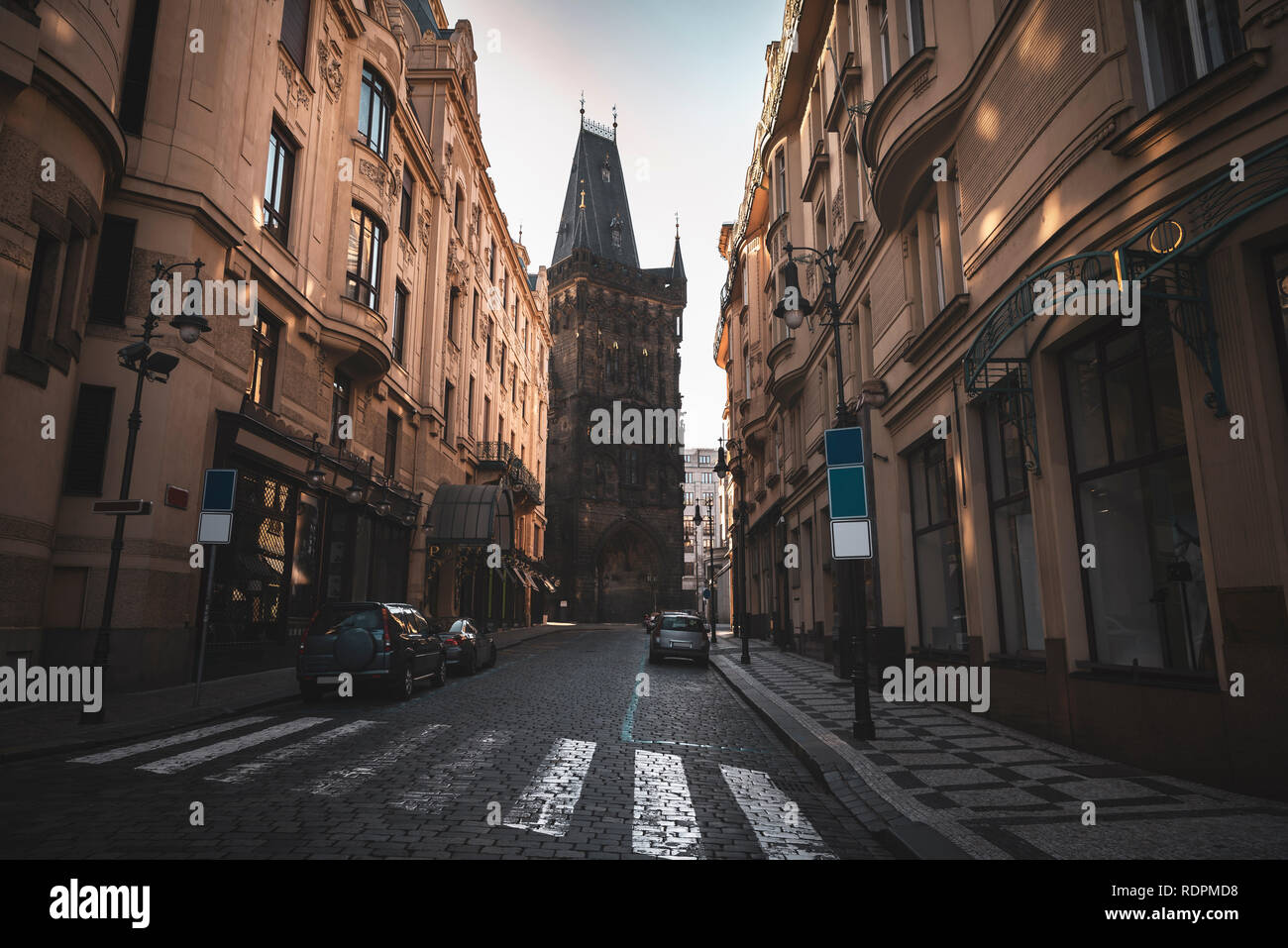 Street with old buildings and an antique tower at the end of it, in the ...