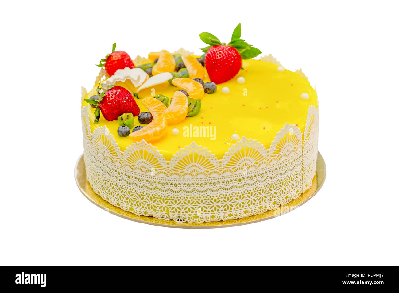 Beautiful delicious yellow cake with fruit and caramel decorations with ...