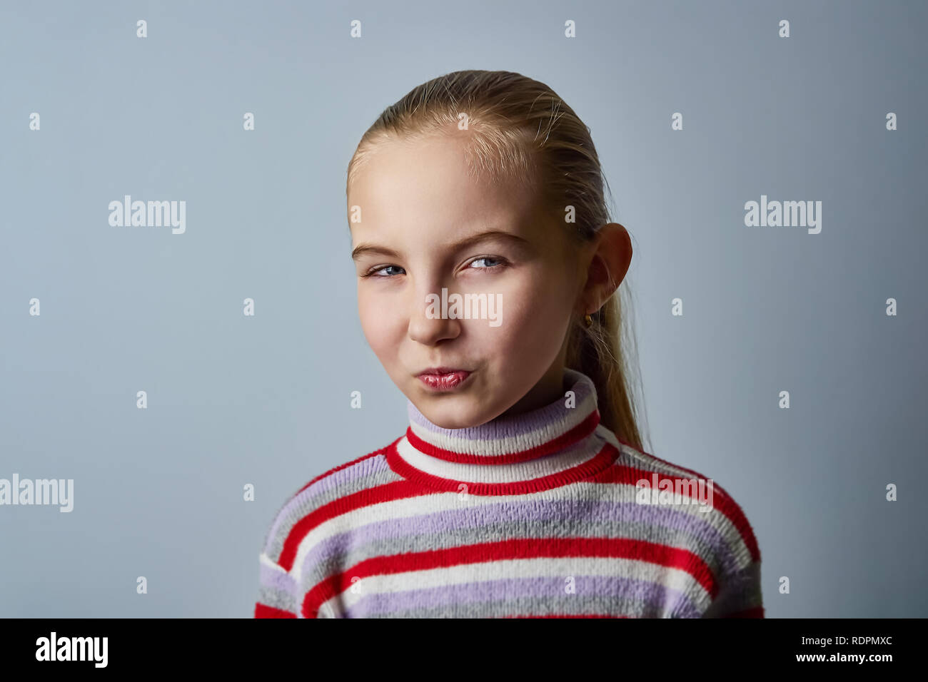 portrait of a girl, shows emotions on the face, on a blue background ...