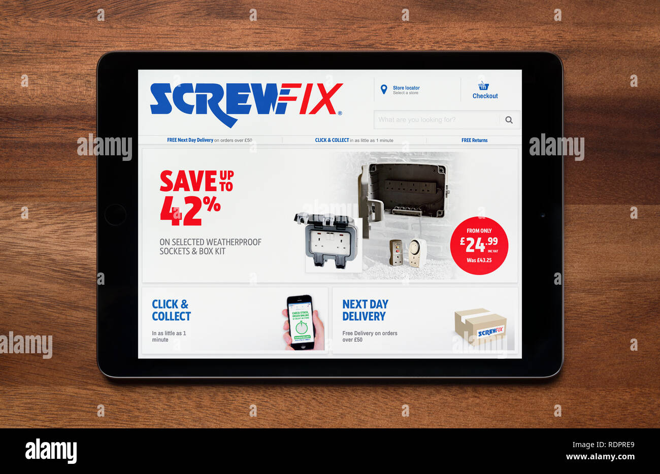 The website of Screwfix is seen on an iPad tablet, which is resting on ...