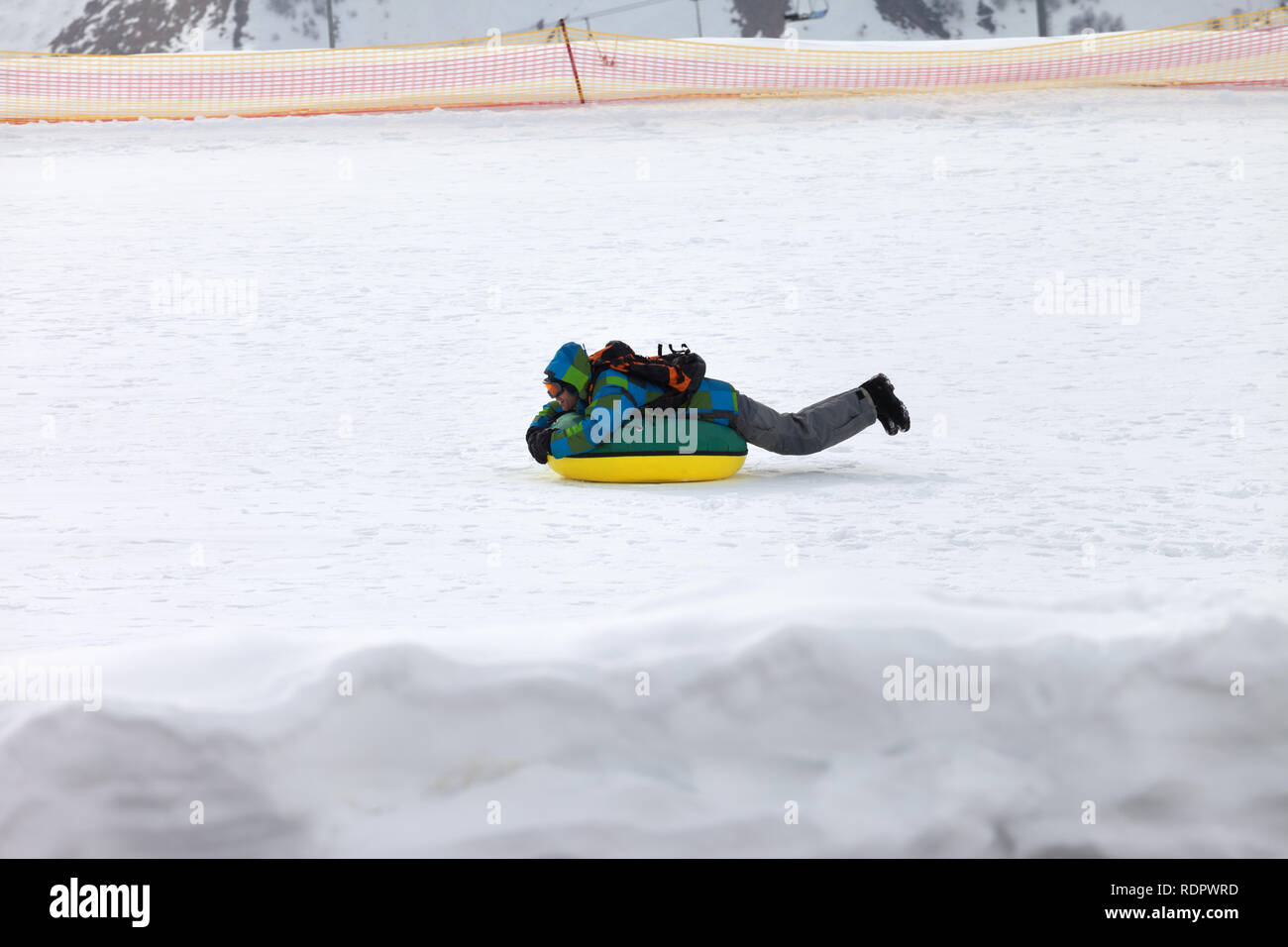 Snow tubing on ski resort at sunny winter day in snowy mountains Stock ...