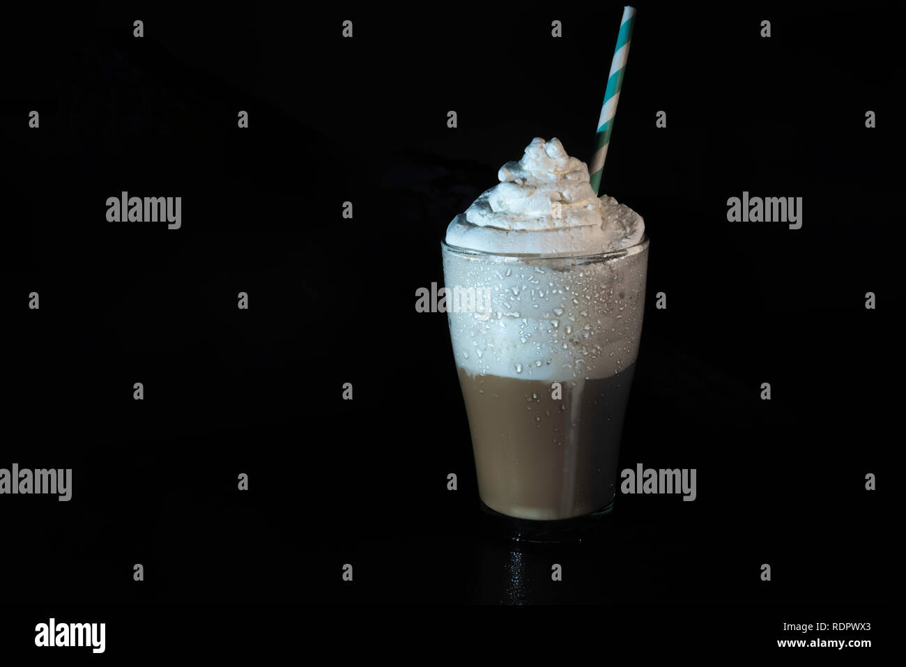 multilayer coffee or cappuccino in a glass cup on black background and ...