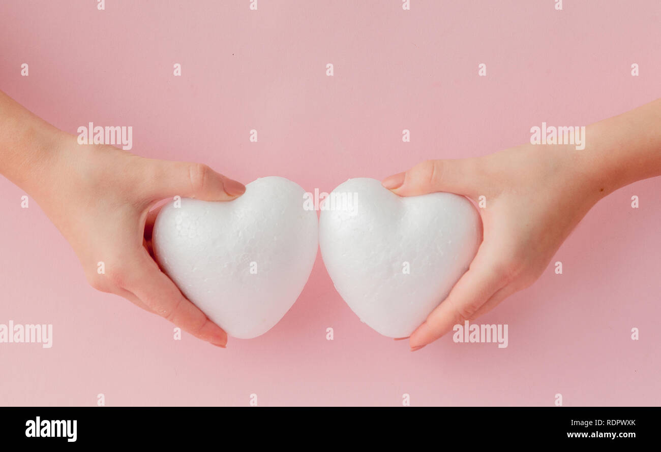 White empty love hearts in hands on pink background Stock Photo - Alamy
