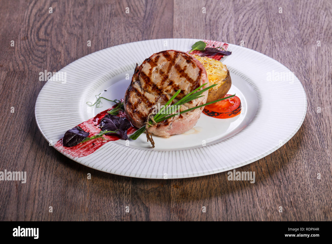 Grilled pork loin with baked potato Stock Photo - Alamy
