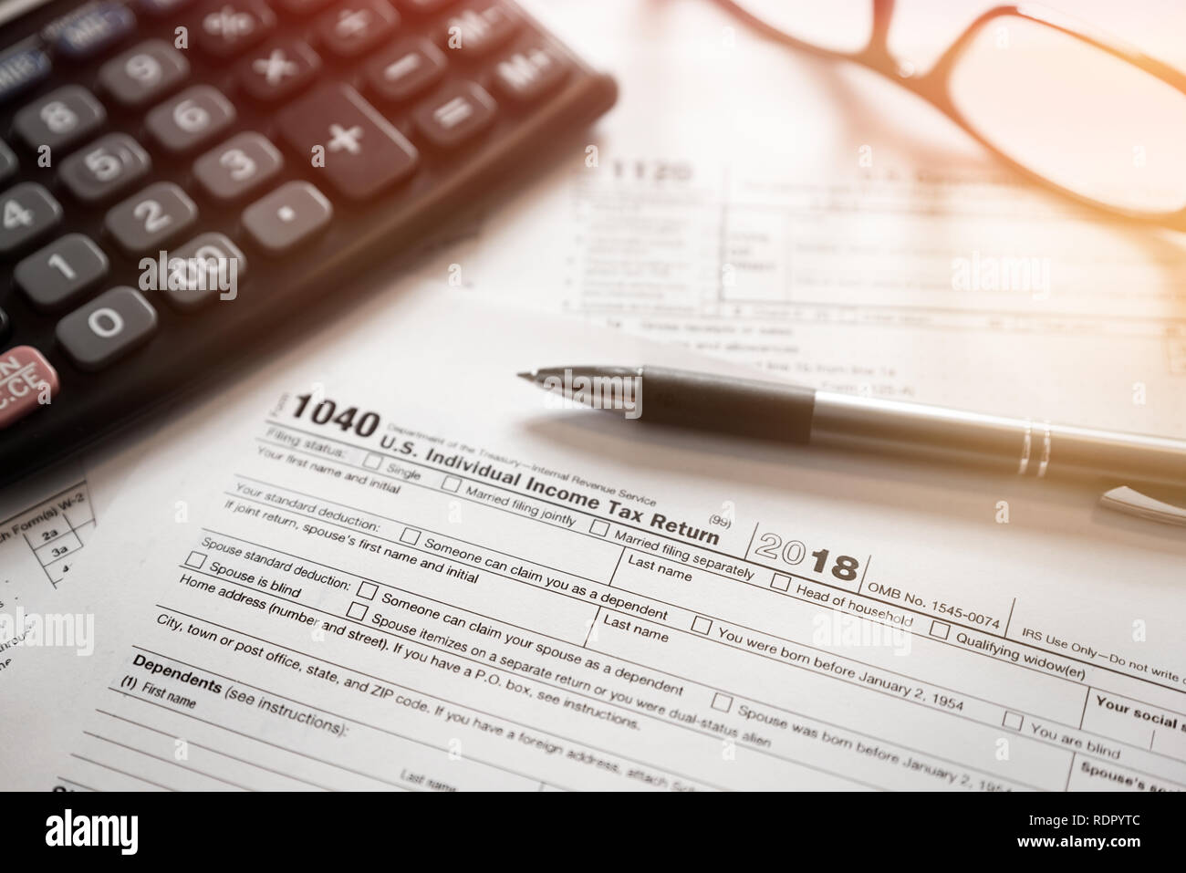 U.S. Individual income tax return. Tax form 1040 with eyeglasses and ...