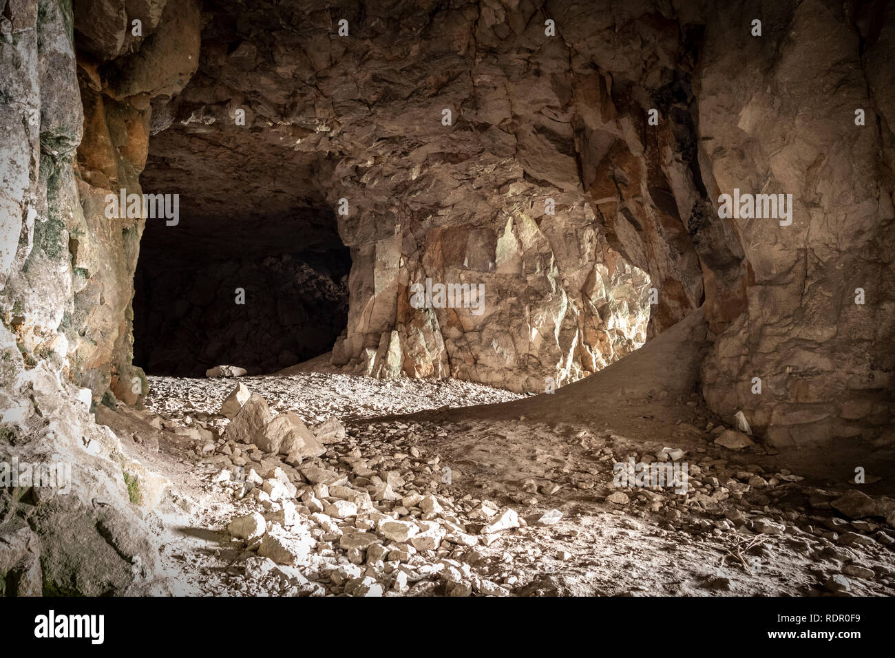 In the corridors of a creepy dark cave Stock Photo - Alamy