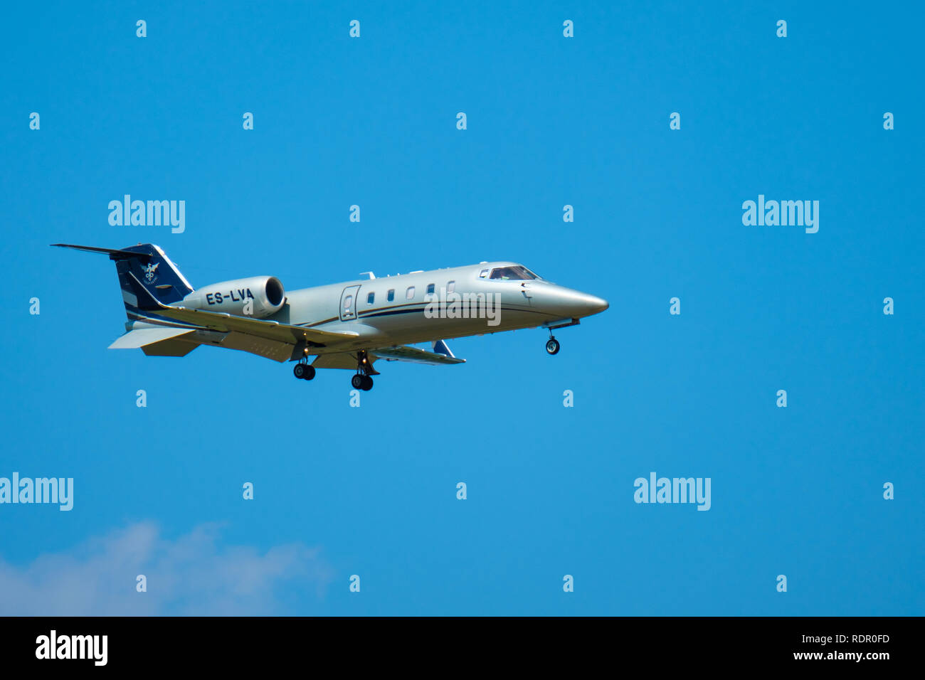 Small private jet airplane preparing for landing at day time in ...