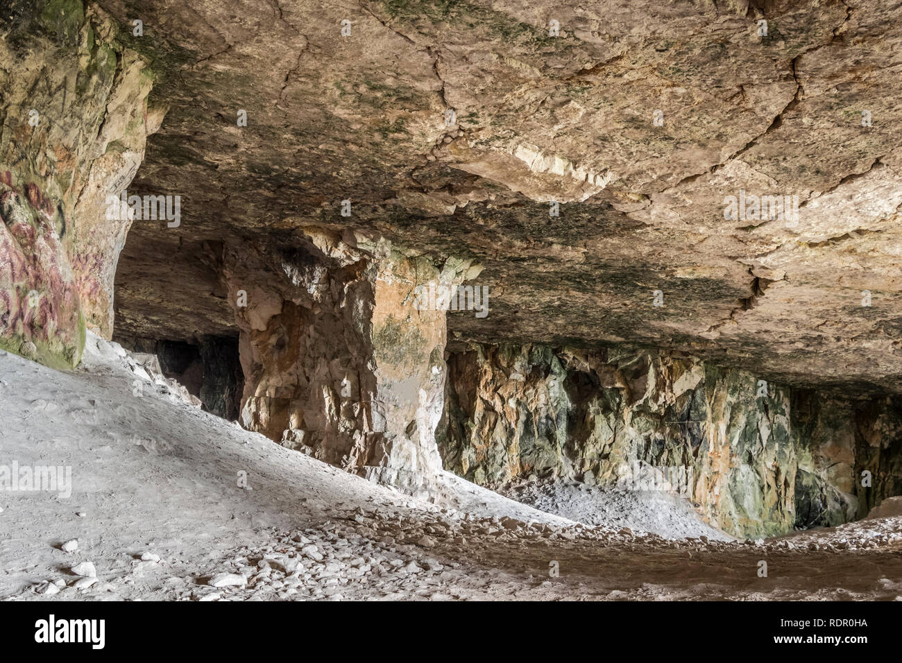 In the corridors of a creepy dark cave Stock Photo - Alamy