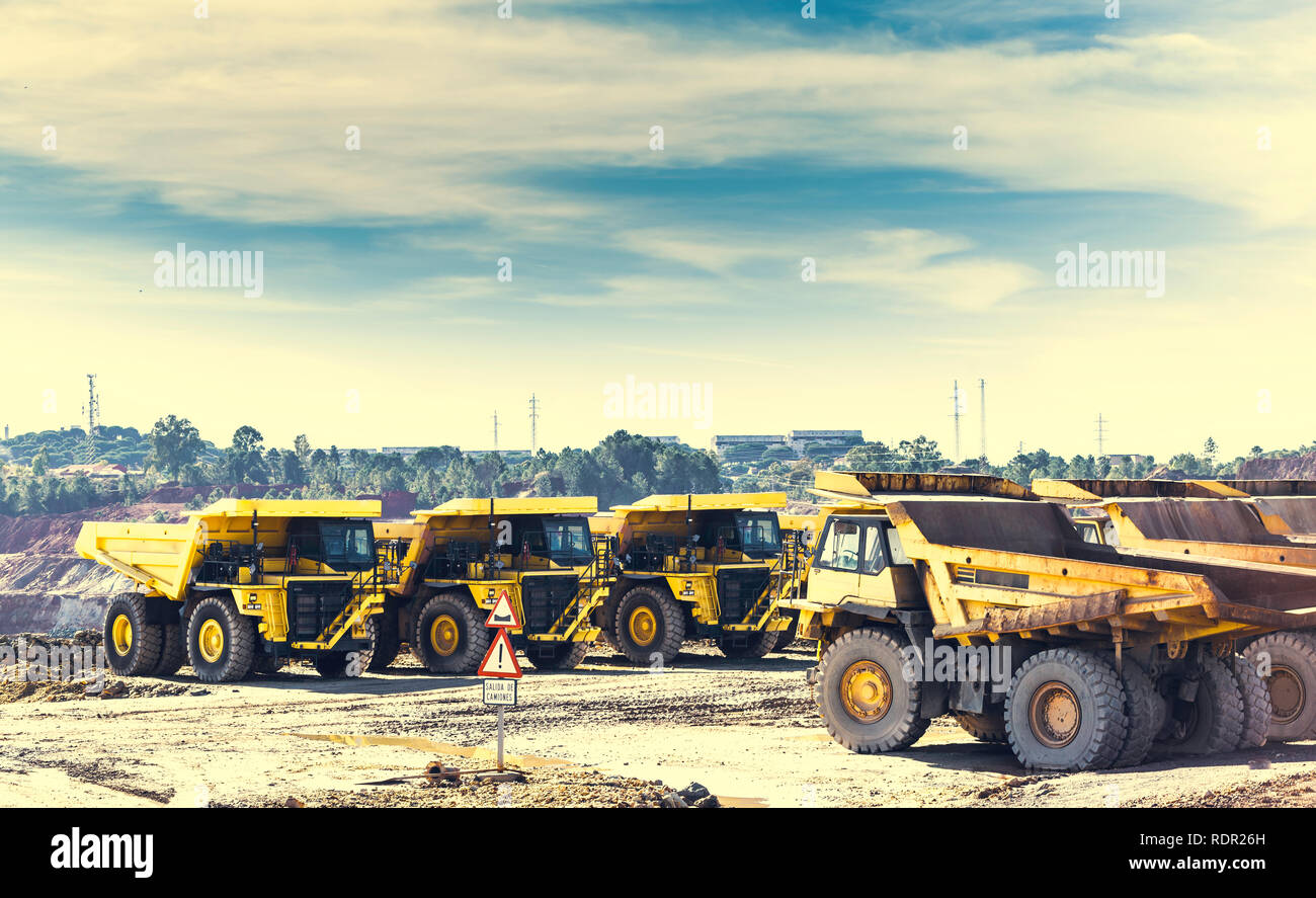 Yellow dumper trucks in mine of Riotinto put in row, with traffic ...
