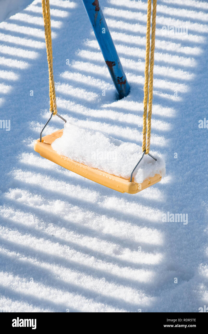 Detail of swing seat covered with snow in winter Stock Photo - Alamy