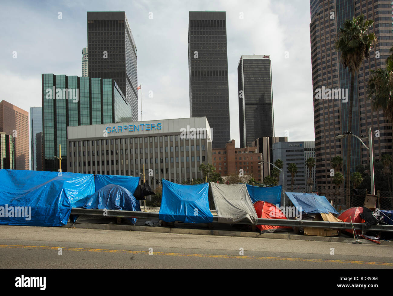 A homeless encampment next to the 110 Freeway, downtown Los Angeles ...