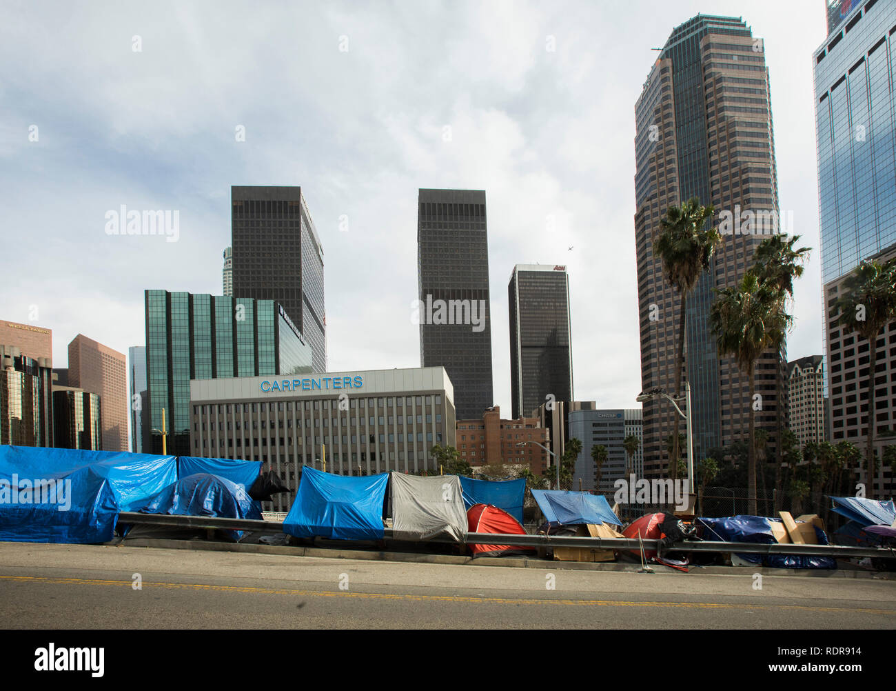 A homeless encampment next to the 110 Freeway, downtown Los Angeles ...